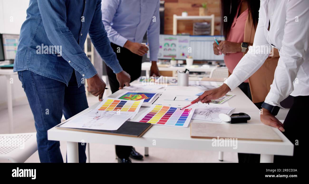 Designer Group At Desk Discussing Custom House Remodel Stock Photo - Alamy