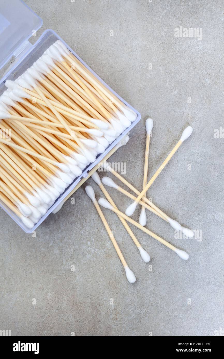 Natural wood and cotton ear buds on mottled gray background Stock Photo ...