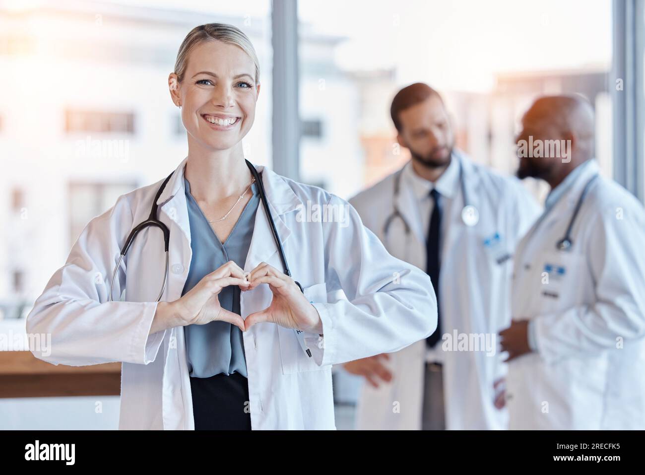Healthcare, heart and hands with portrait of doctor in hospital for ...