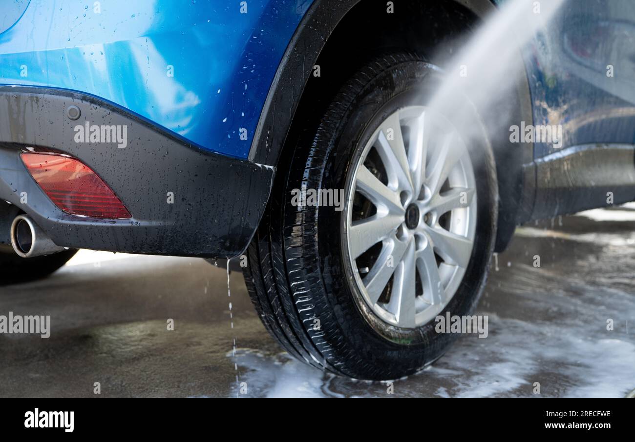 Car washing with high pressure water spray. Car cleaning. Auto care ...