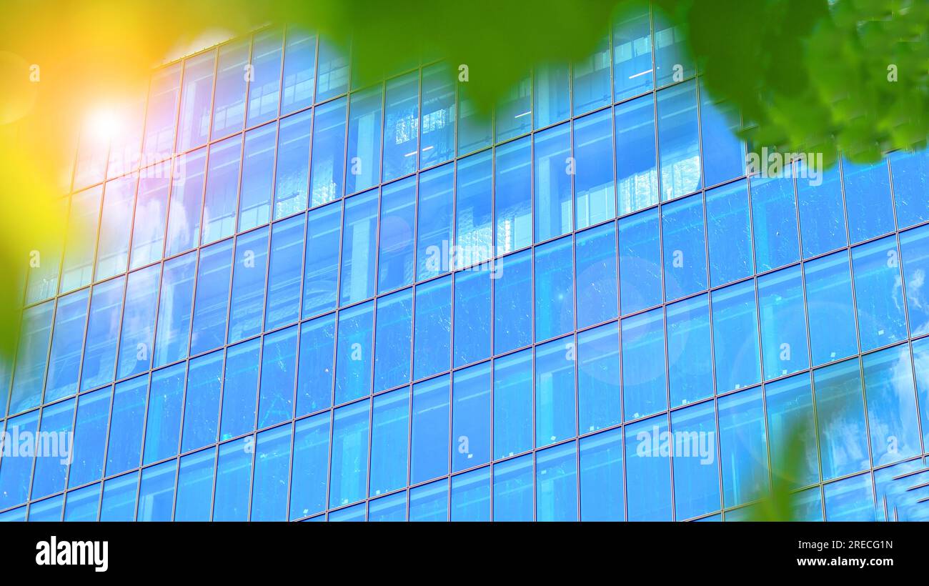 Reflection of modern commercial building on glass with sunlight. Eco ...