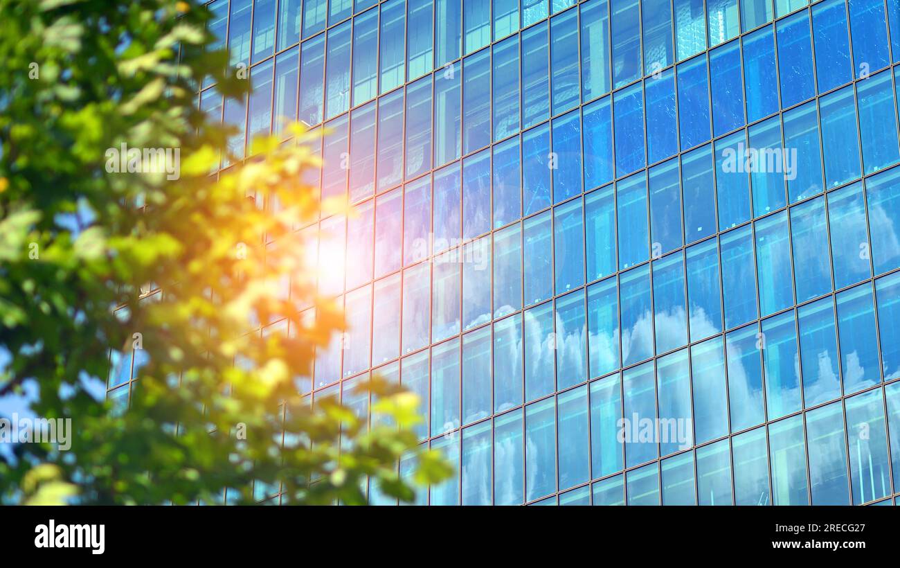 Reflection of modern commercial building on glass with sunlight. Eco ...