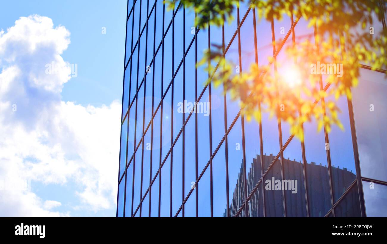 Reflection of modern commercial building on glass with sunlight. Eco ...