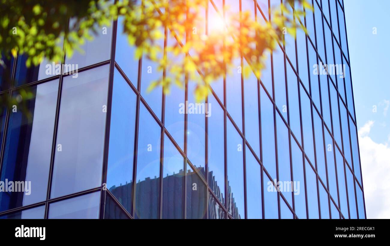 Reflection of modern commercial building on glass with sunlight. Eco ...