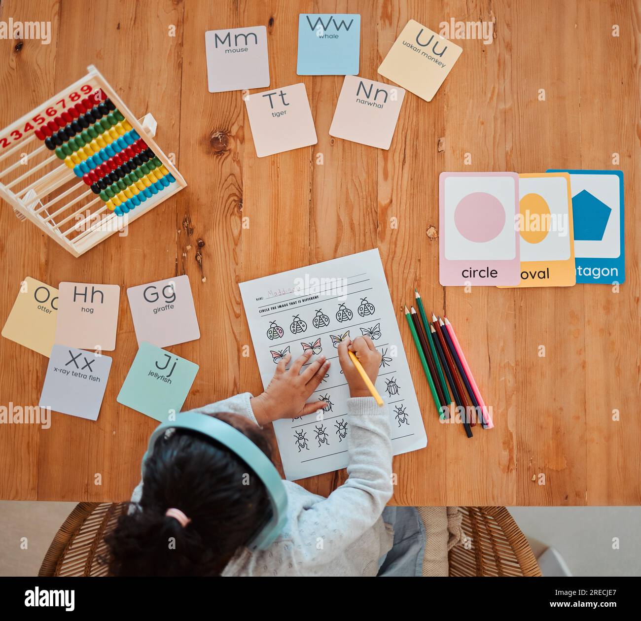 Above, child and girl writing on table for homework or remote learning ...