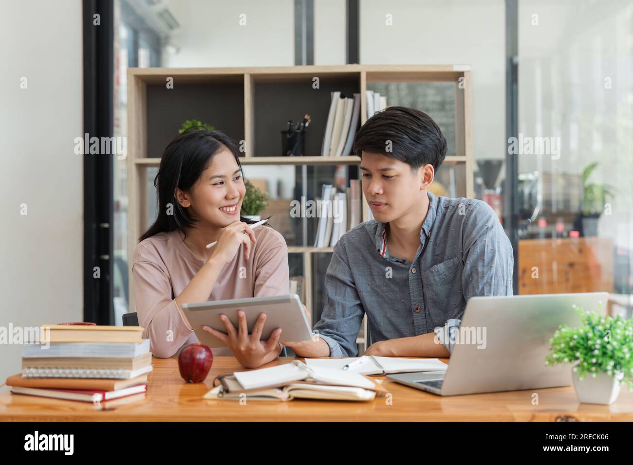 Education, teaching, learning, technology and people concept. Two Asian ...