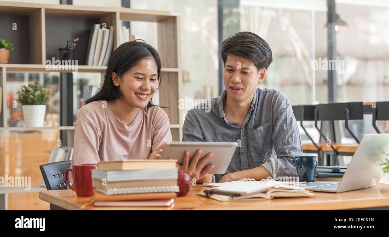 Education, teaching, learning, technology and people concept. Two Asian ...