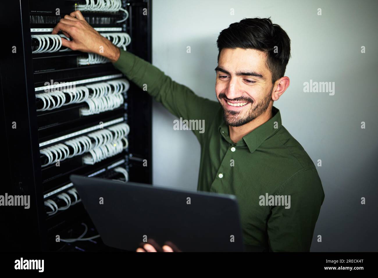 Laptop, maintenance and male technician in a server room for technical ...