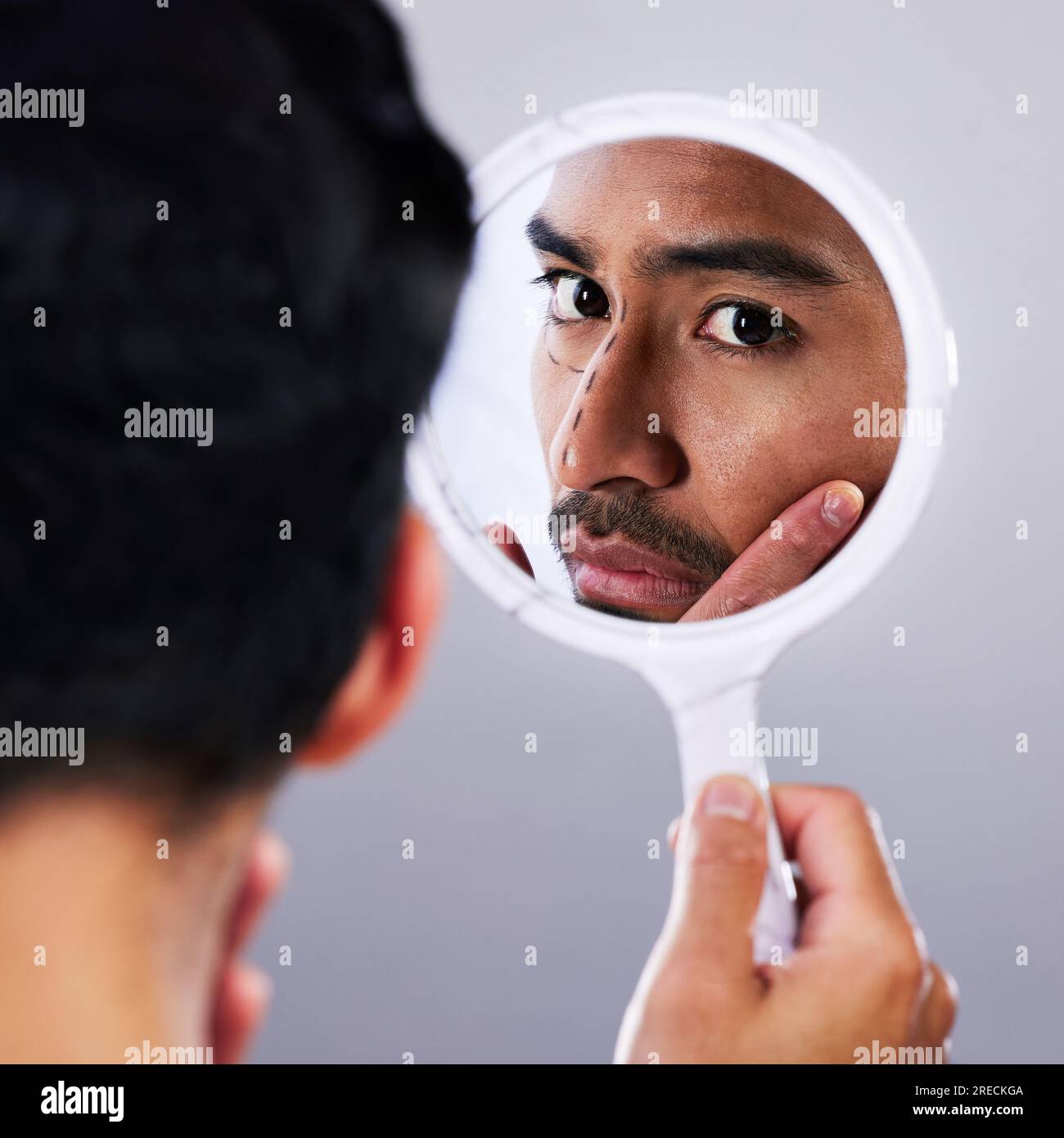 Plastic surgery, mirror and face drawing lines with studio and man with ...