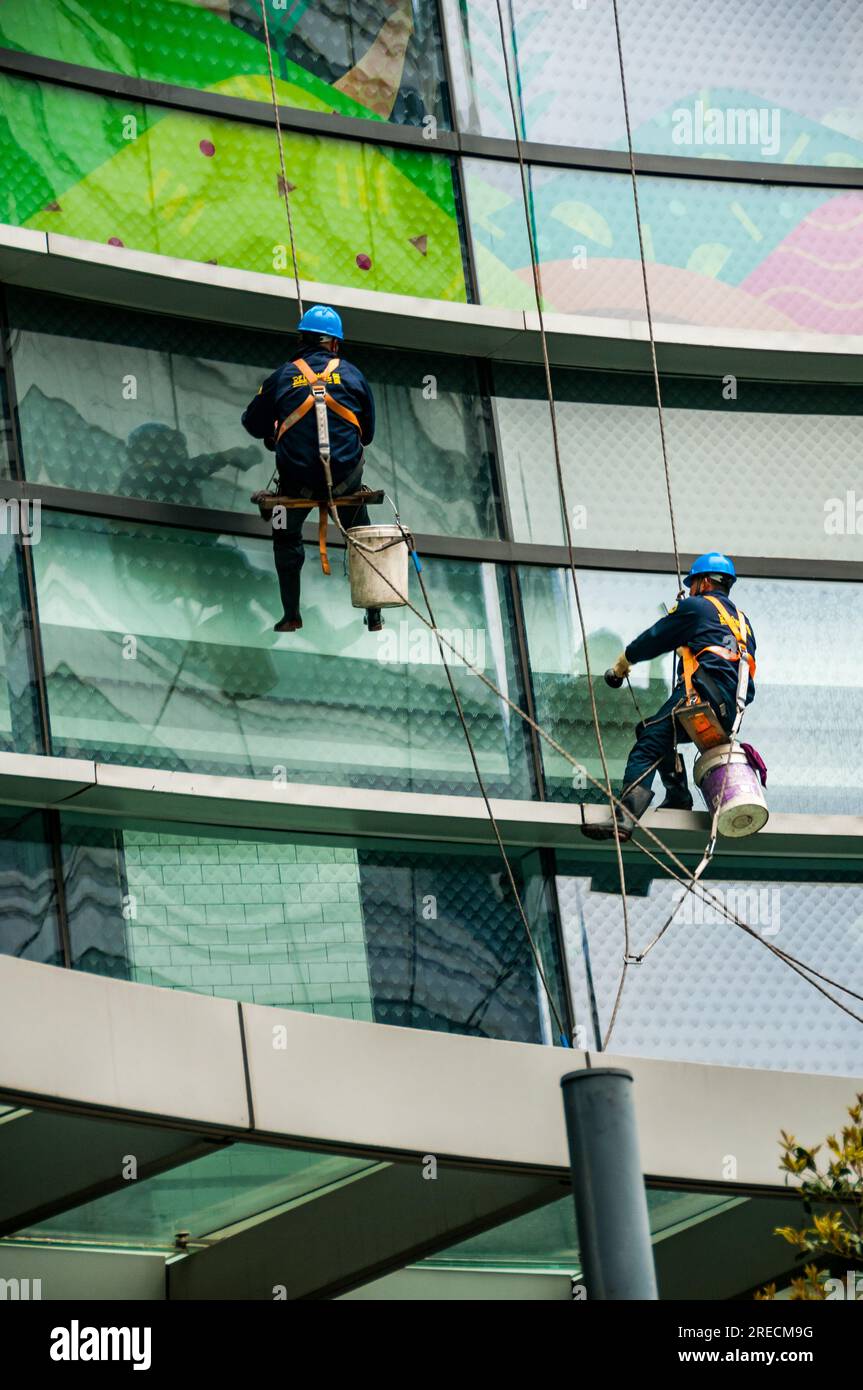 Two window cleaners cleaning the Raffles City Changning building in ...