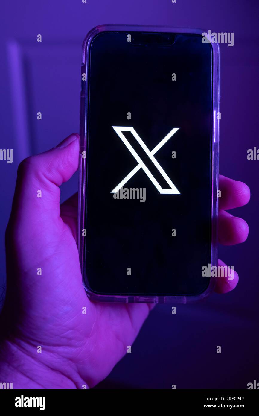 Mobile phone in one hand with the symbol X, the new name of the former ...