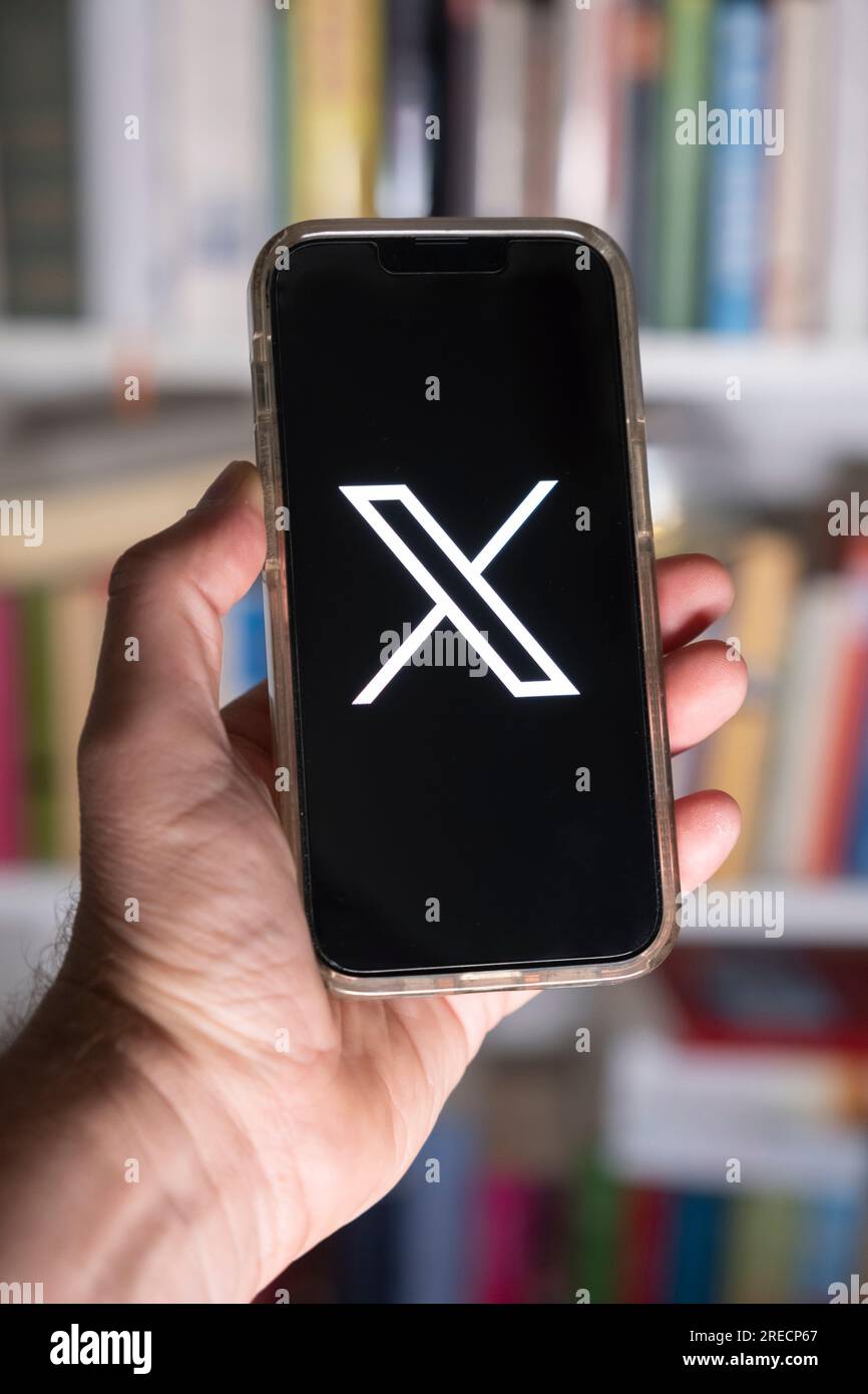 Mobile phone in one hand with the symbol X, the new name of the former ...