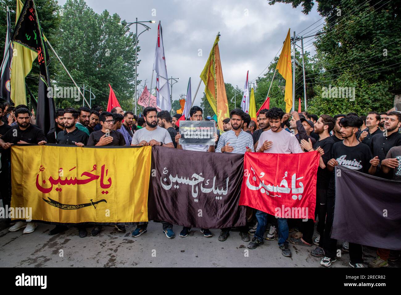 Kashmiri Shiite Muslim mourners carrying religious flags as they take ...