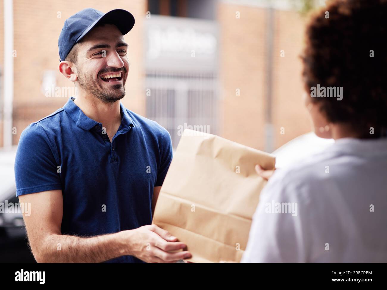 Happy delivery man, package and a customer at door with a paper bag for ...