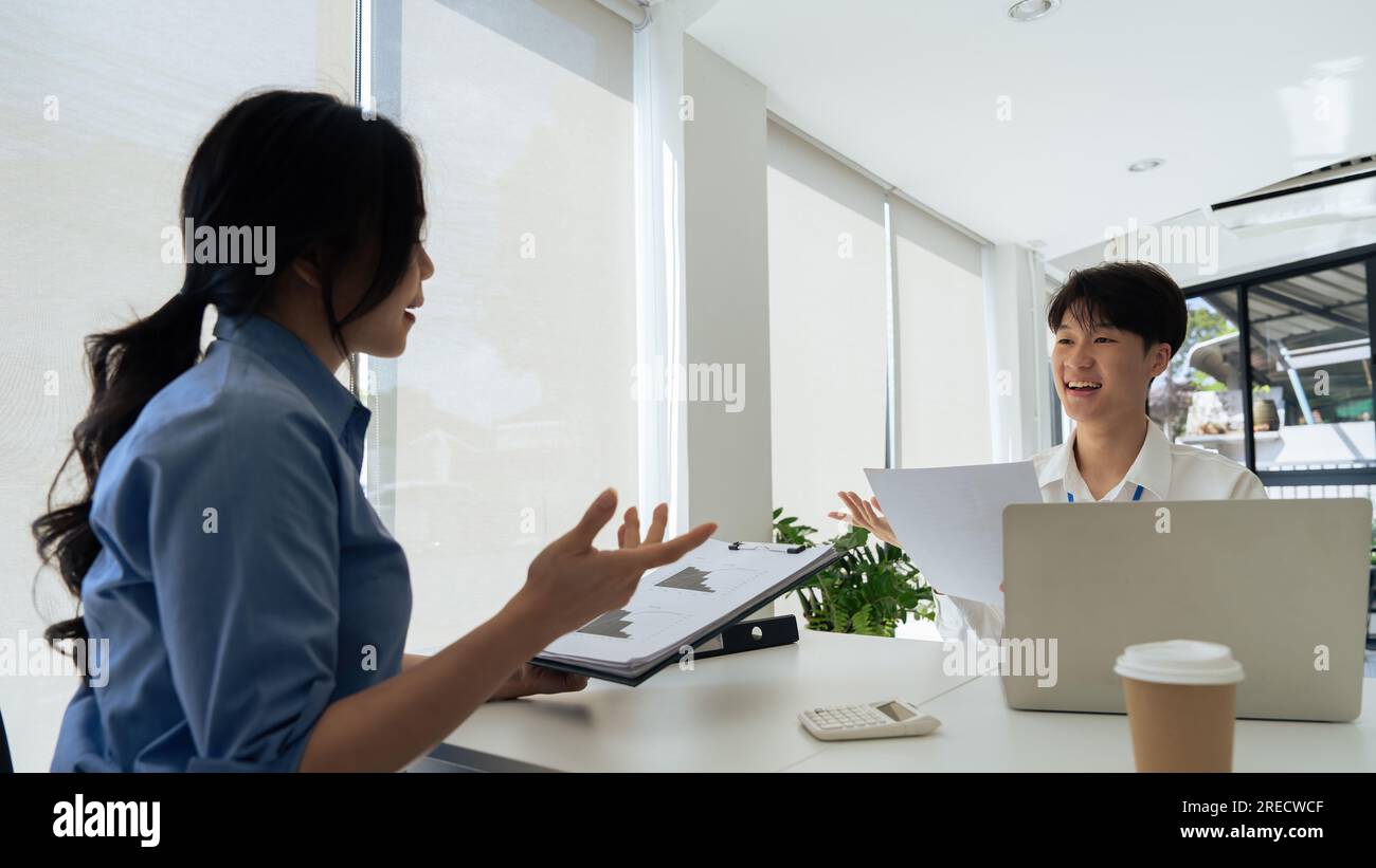 employee discuss report together in the office Stock Photo - Alamy