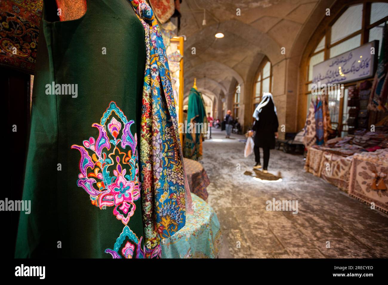 Woman wearing a hijab walking past clothing for sale in the Grand ...