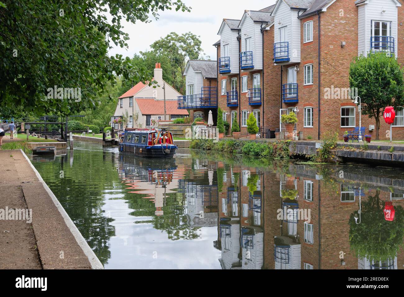 A small narrow boat exiting Thames Lock on the River Wey navigation ...