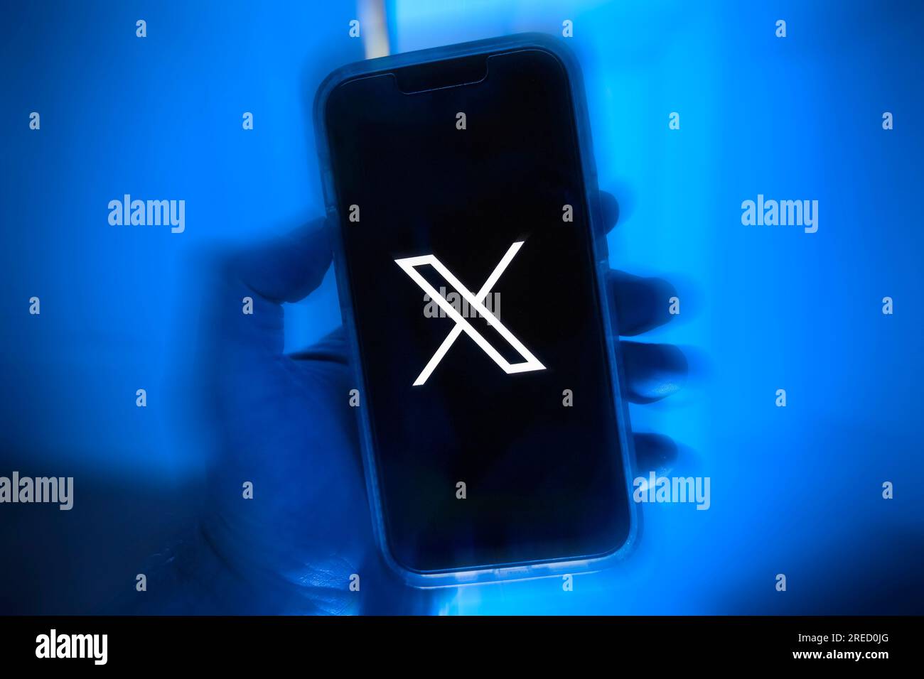 Mobile phone in one hand with the symbol X, the new name of the former ...