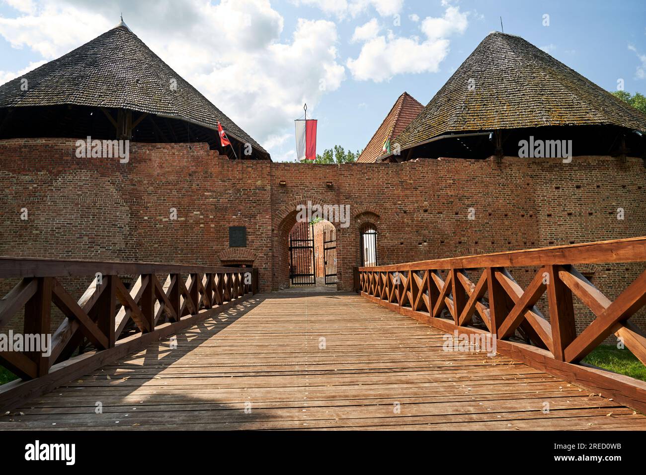 wooden bridge over the moat and a medieval fortified castle in ...
