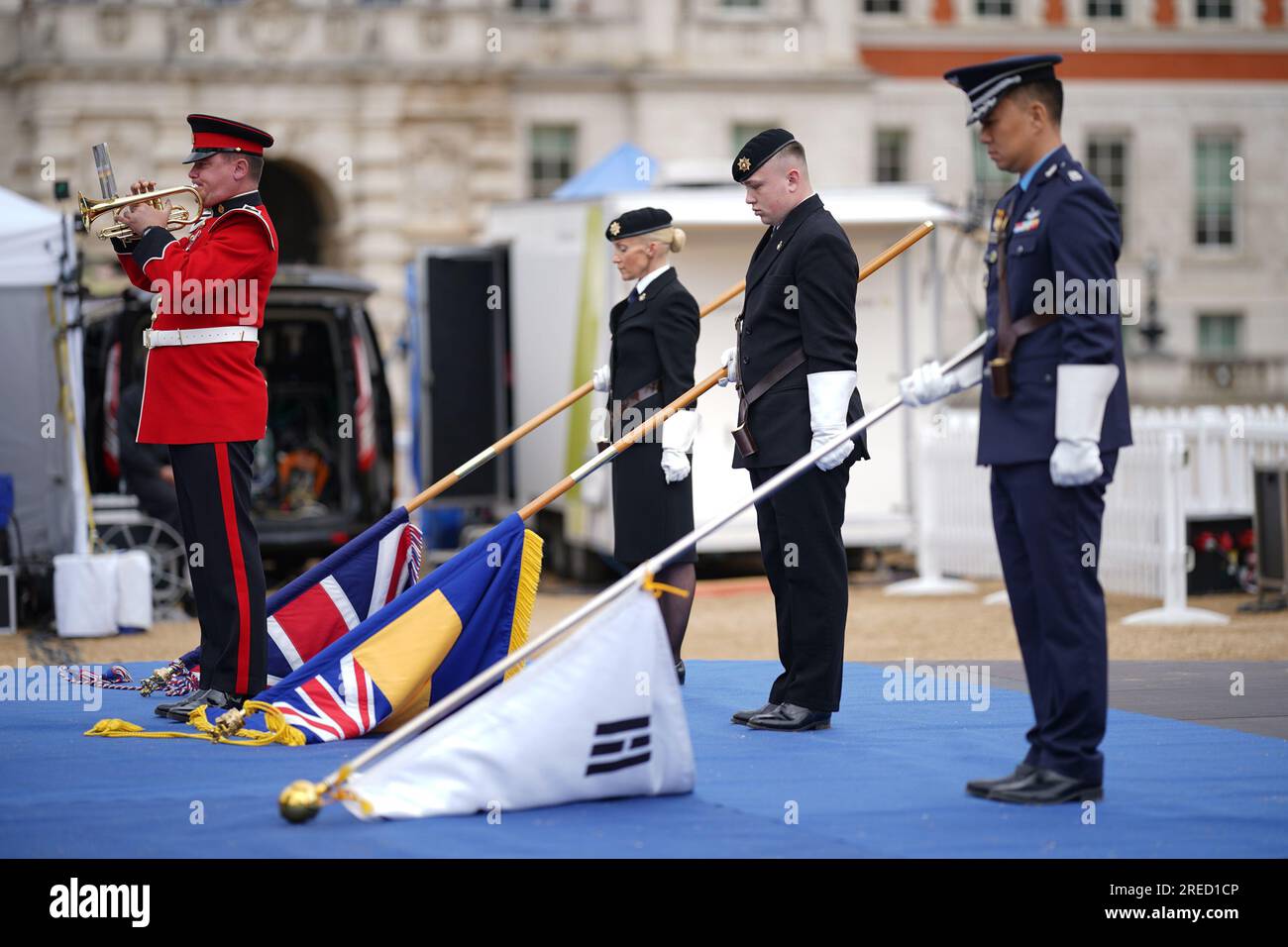 Flag bearers lower their flags as a bugler plays the Last Post, during ...