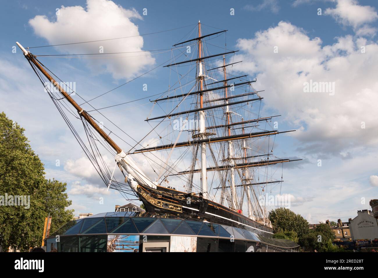 Nannie, the ship's figurehead below the bowsprit of the magnificent Cutty Sark tea clipper tall ...