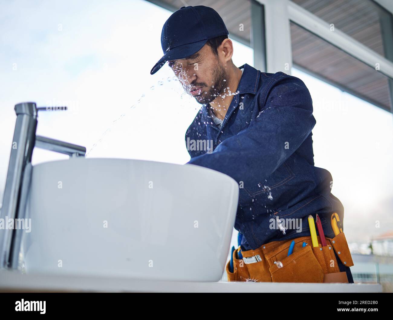 Plumbing, fail and asian man in bathroom with water splash, crisis or ...