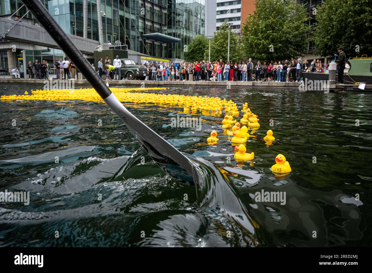 London, UK. 27 July 2023. A staff member uses an oar to coax one ...