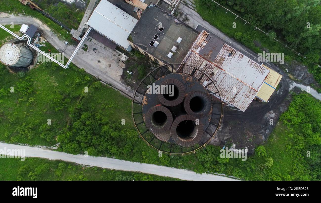 Aerial view of big factory chimney along Stock Photo - Alamy
