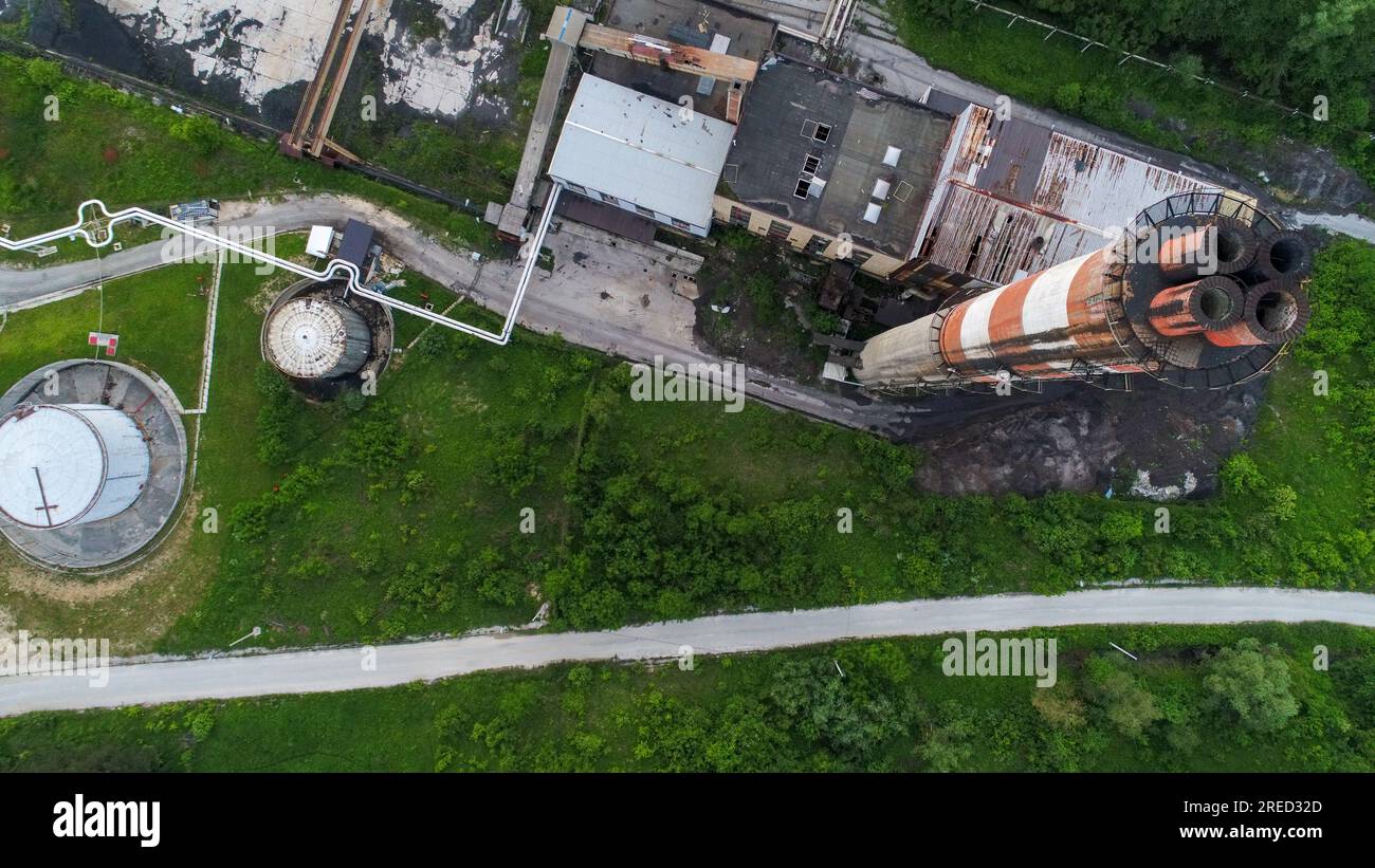 Aerial view of big factory chimney along Stock Photo - Alamy