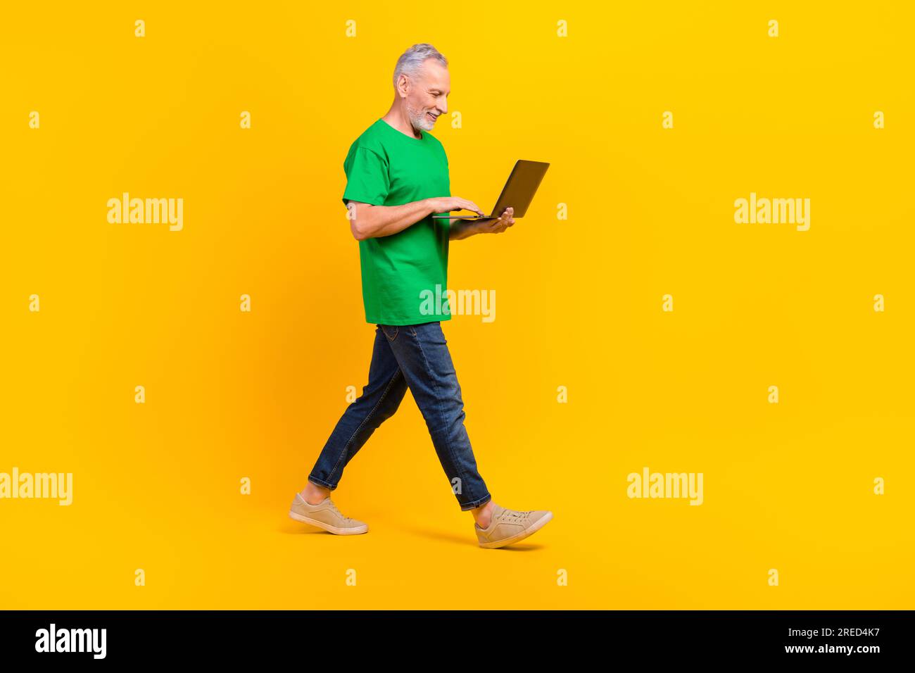 Full body profile portrait of nice aged man walking hold use wireless ...