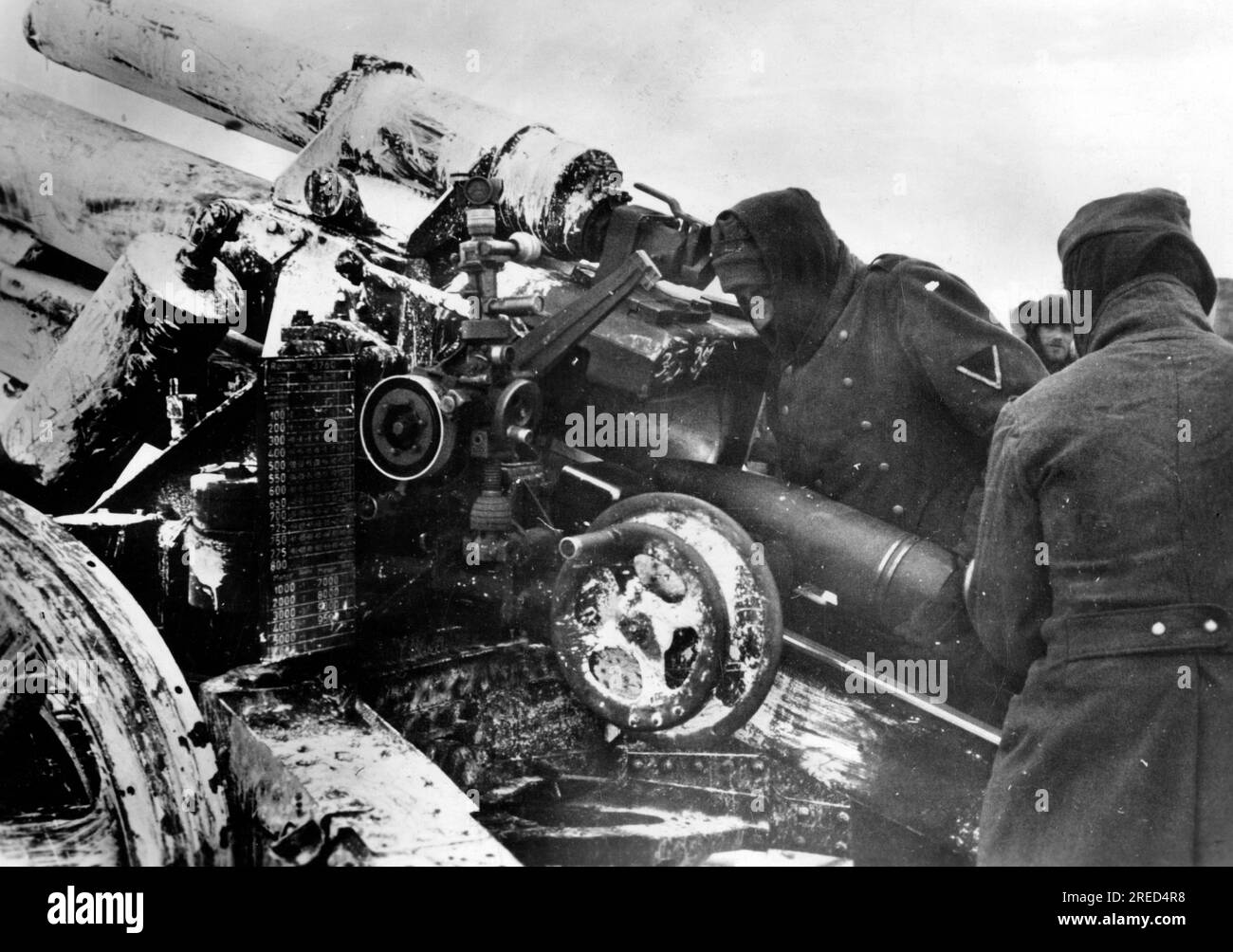 Soldiers of a German artillery battery load their gun, probably a 21cm ...
