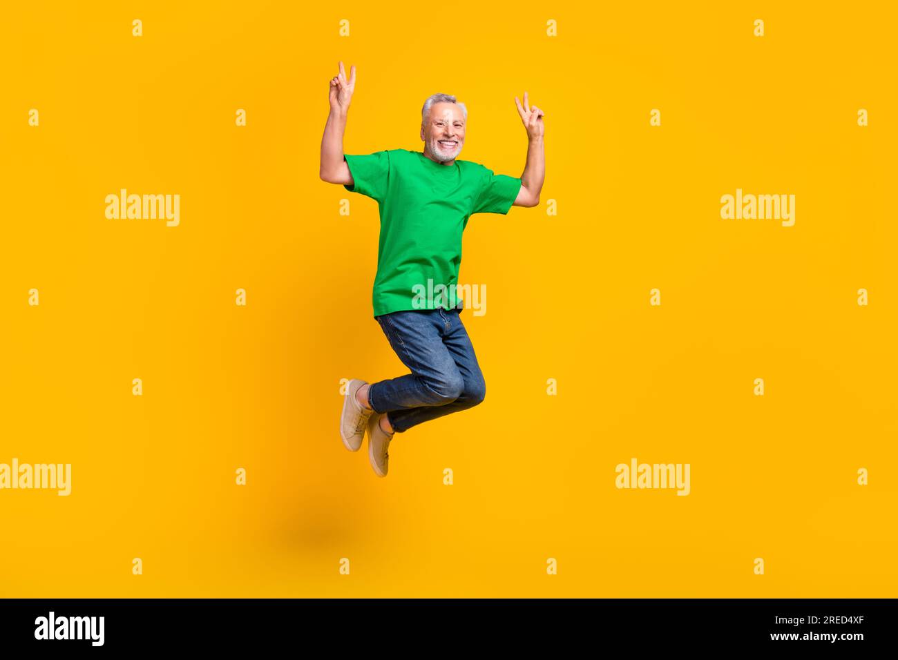 Full length photo of active energetic man jumping hands fingers ...
