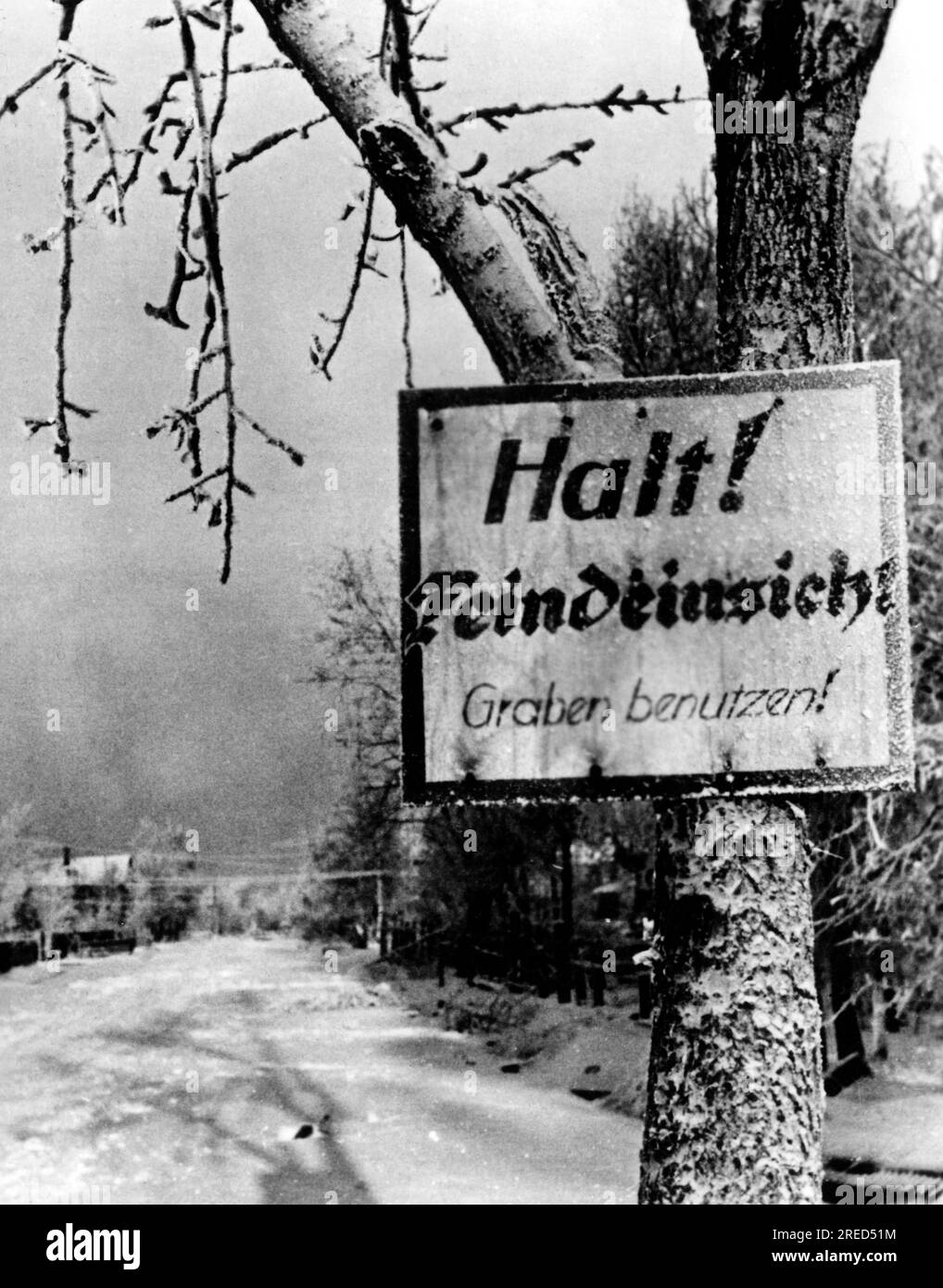 A warning sign cautions against enemy entry and warns to use the ditch ...