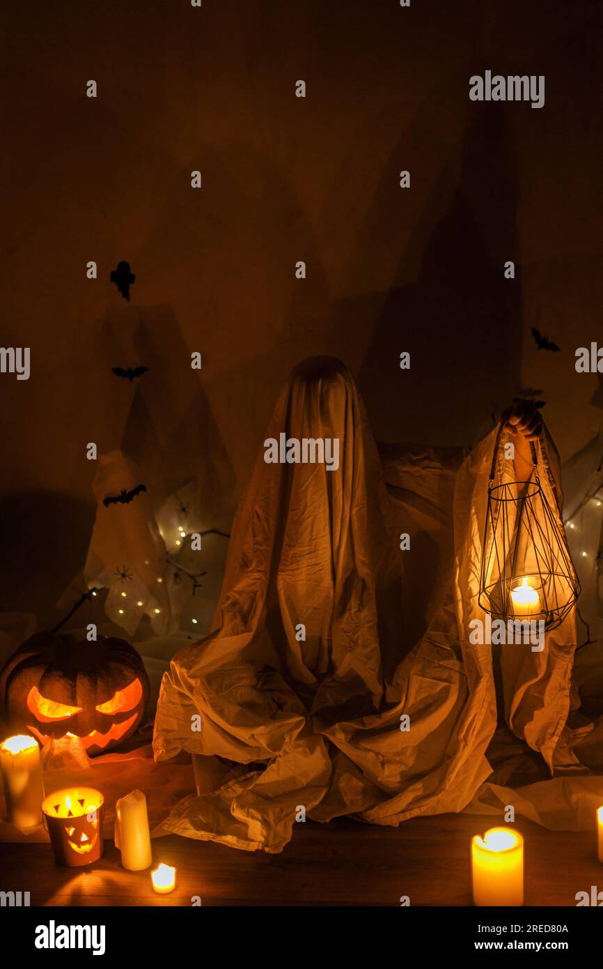 Trick or treat! Scary ghost holding lantern in dark. Scary atmospheric ...