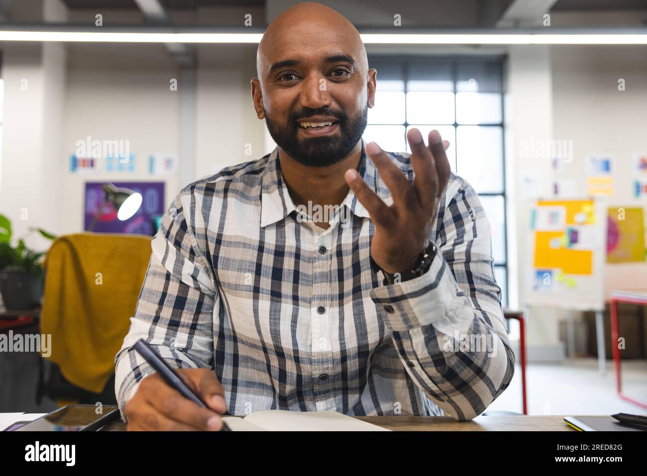 Happy indian man talking looking at the camera during a video call at ...
