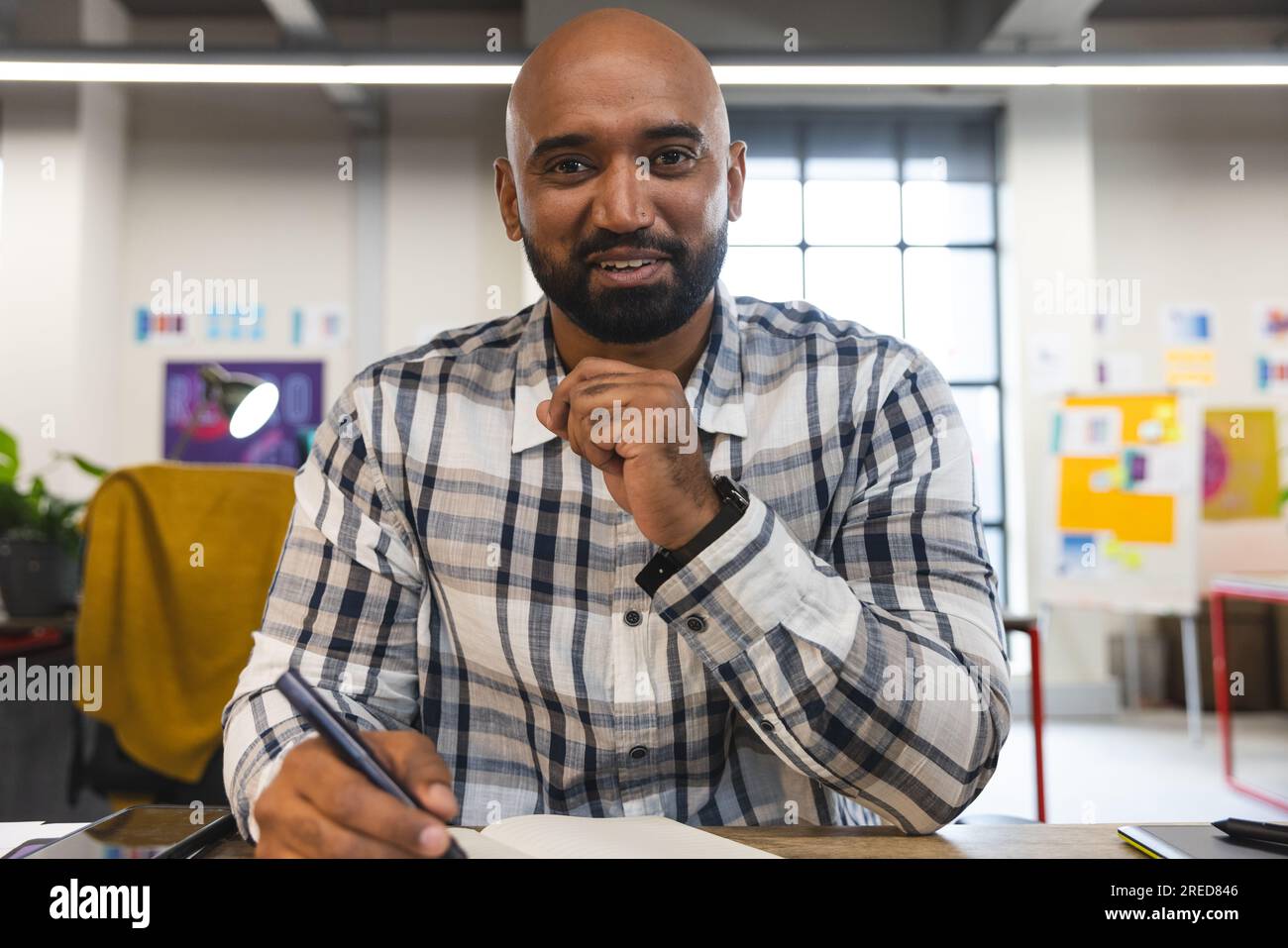 Happy indian man talking looking at the camera during a video call at ...