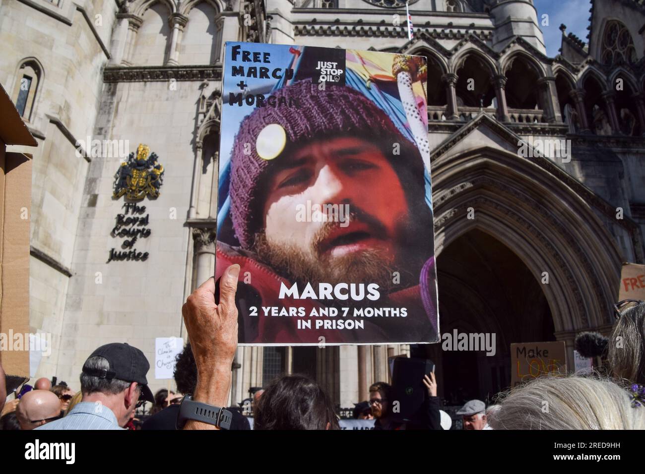 London, UK. 26th July, 2023. A protester holds a picture of Marcus ...