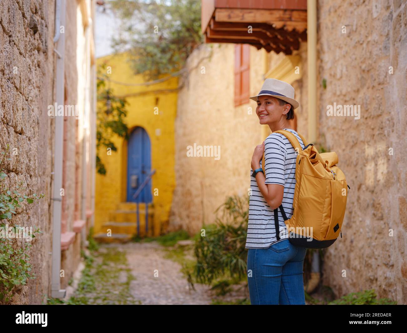 summer trip to Rhodes island Greece. Young Asian woman in striped ...