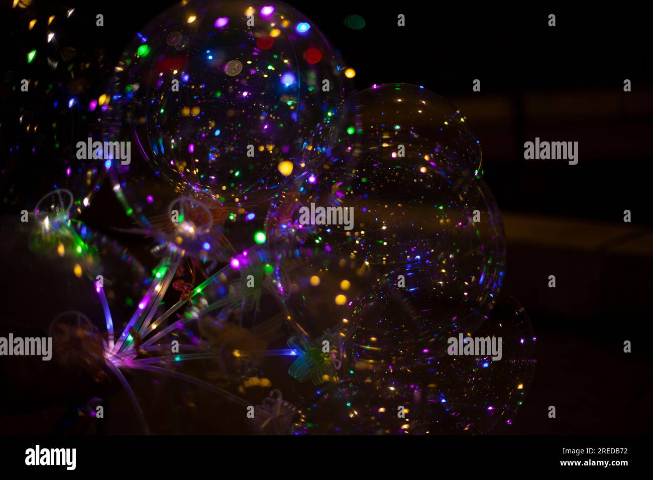 Colored balls in dark. LED Light. Transparent ball with colored lights ...