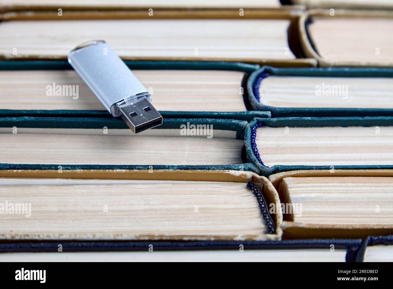 Usb flash drive on stack of paper old books. Keepers and carriers of ...