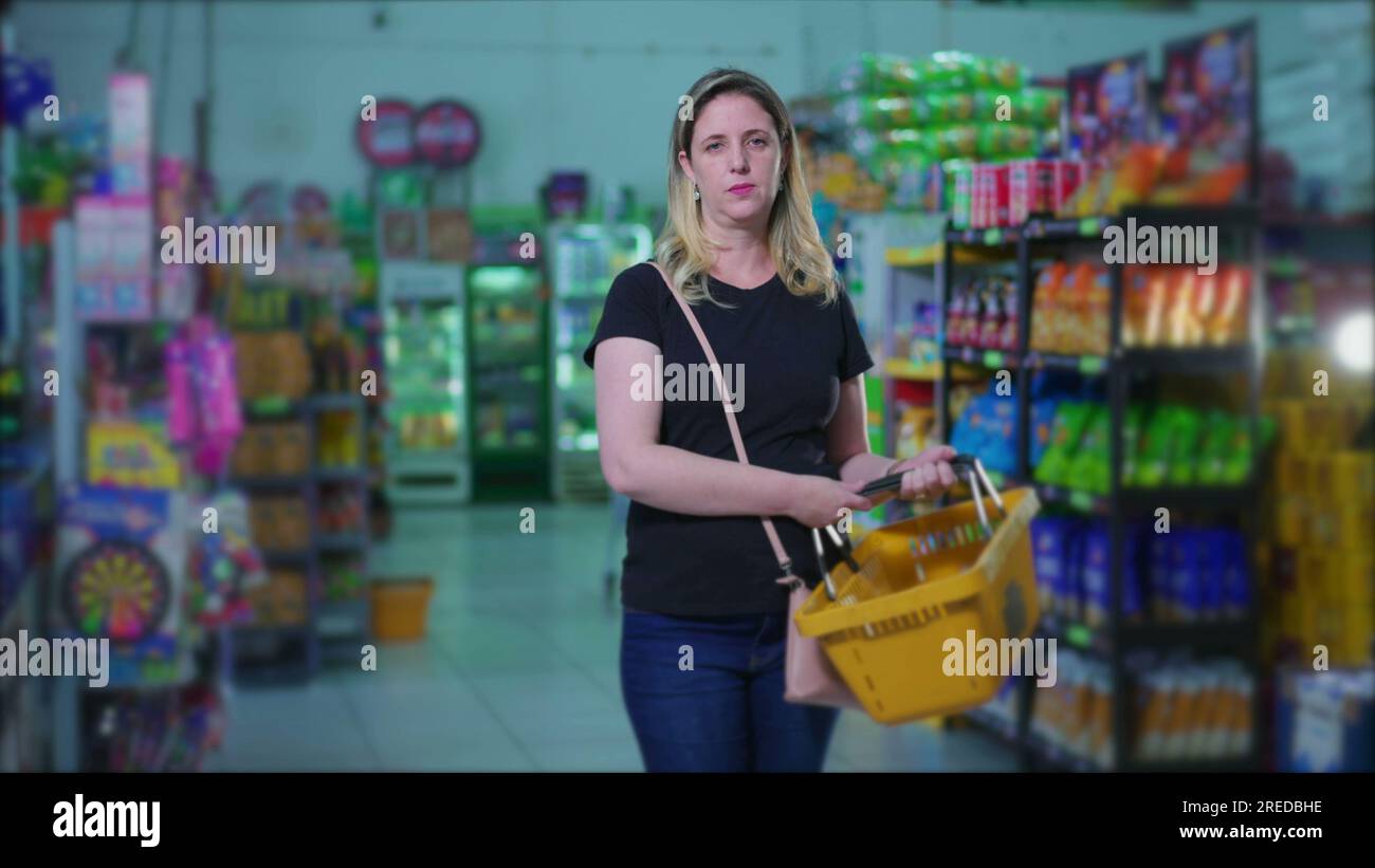 Close-Up Portrait of Serious Female Consumer Holding Basket in ...