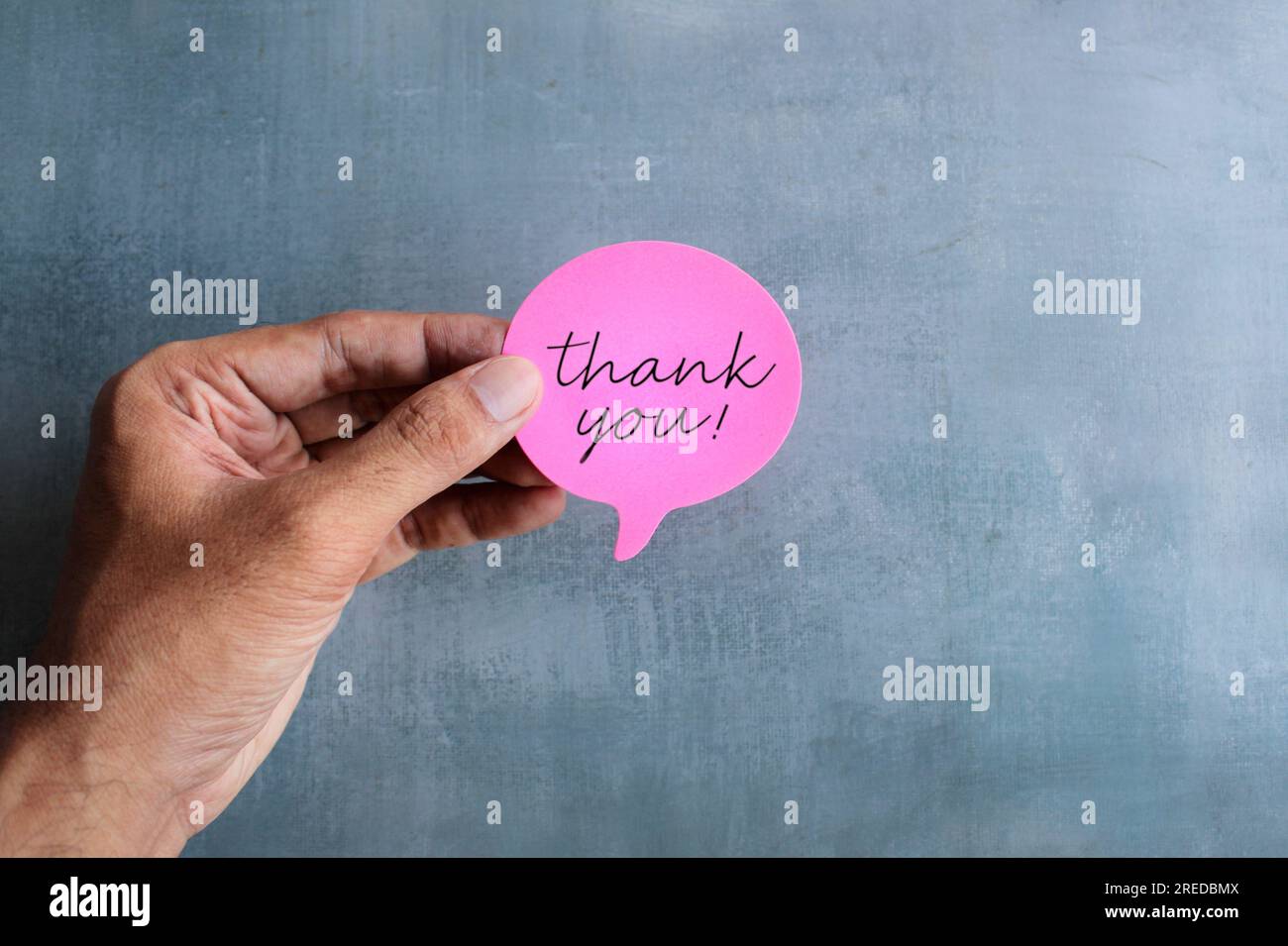 Hand holding speech bubble with text THANK YOU!. Appreciation and ...