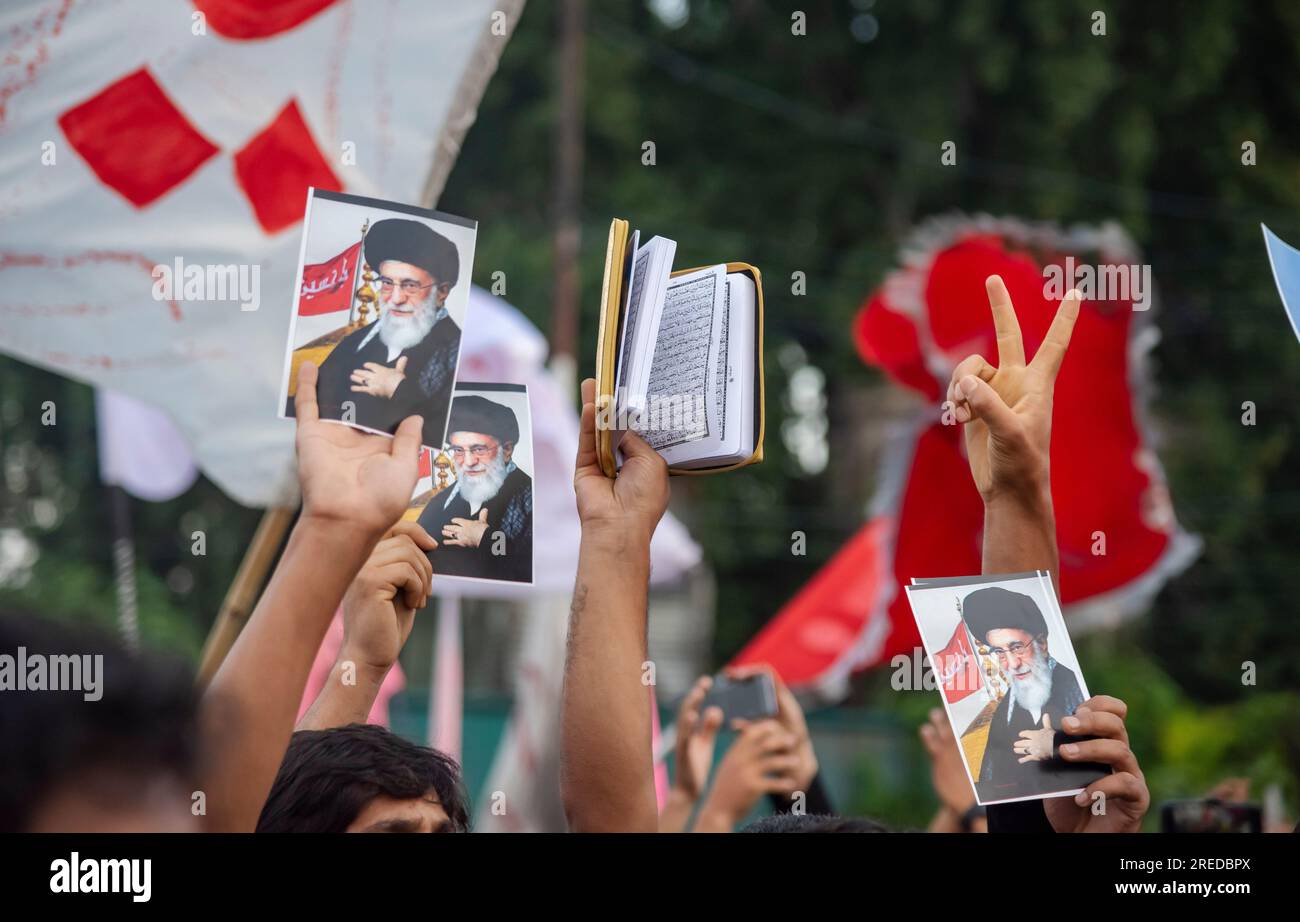 Kashmiri Shia Muslims hold portraits of Iranian leader and the Quran ...