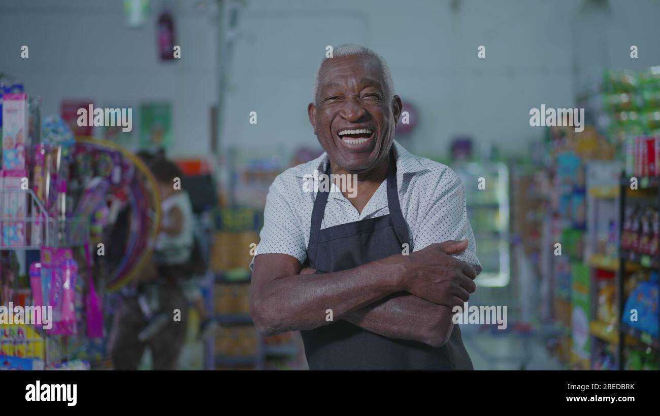 Happy African American employee and female customer laughing and ...