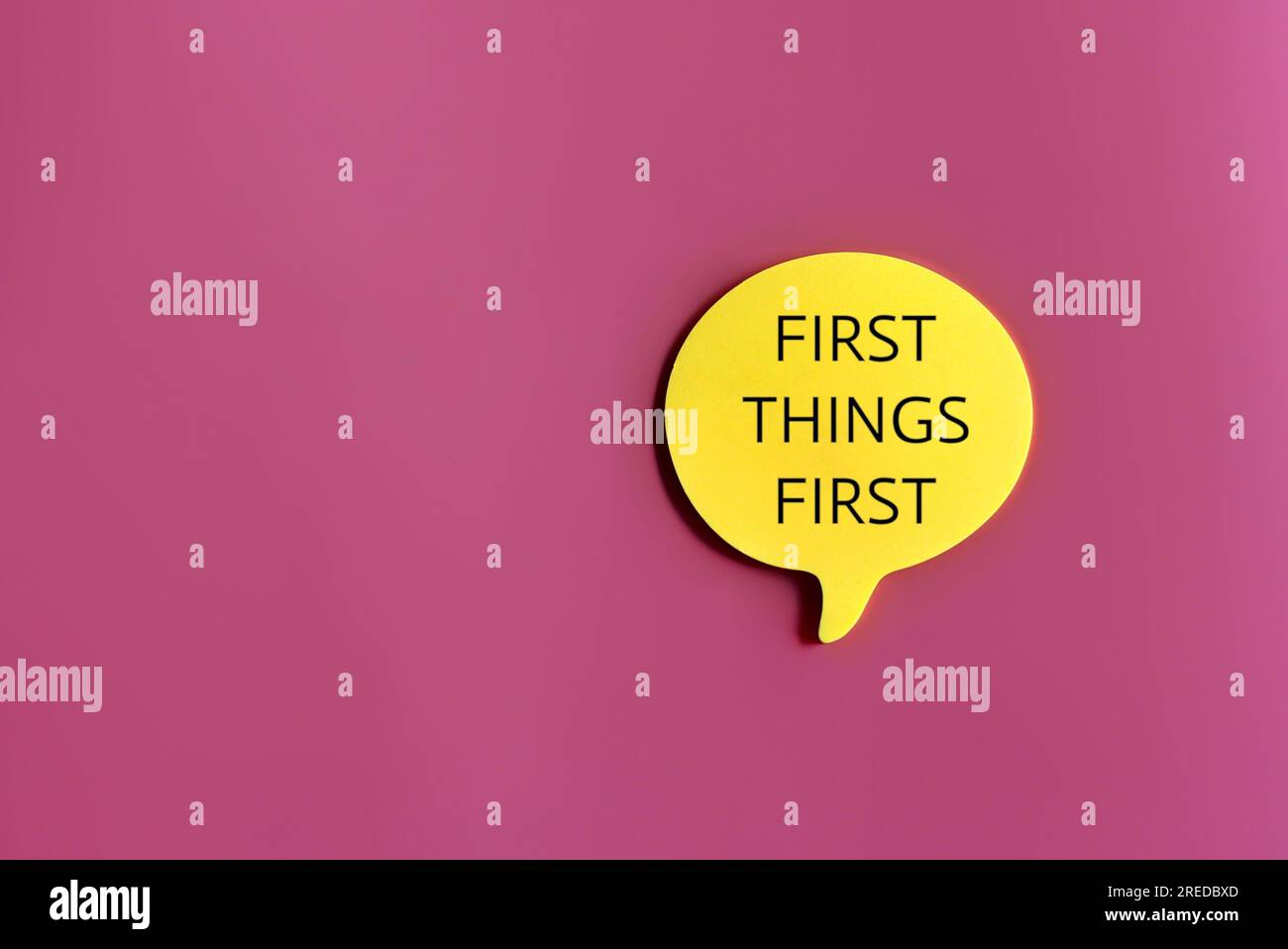 Top view image of speech bubble with text FIRST THINGS FIRST on pink ...