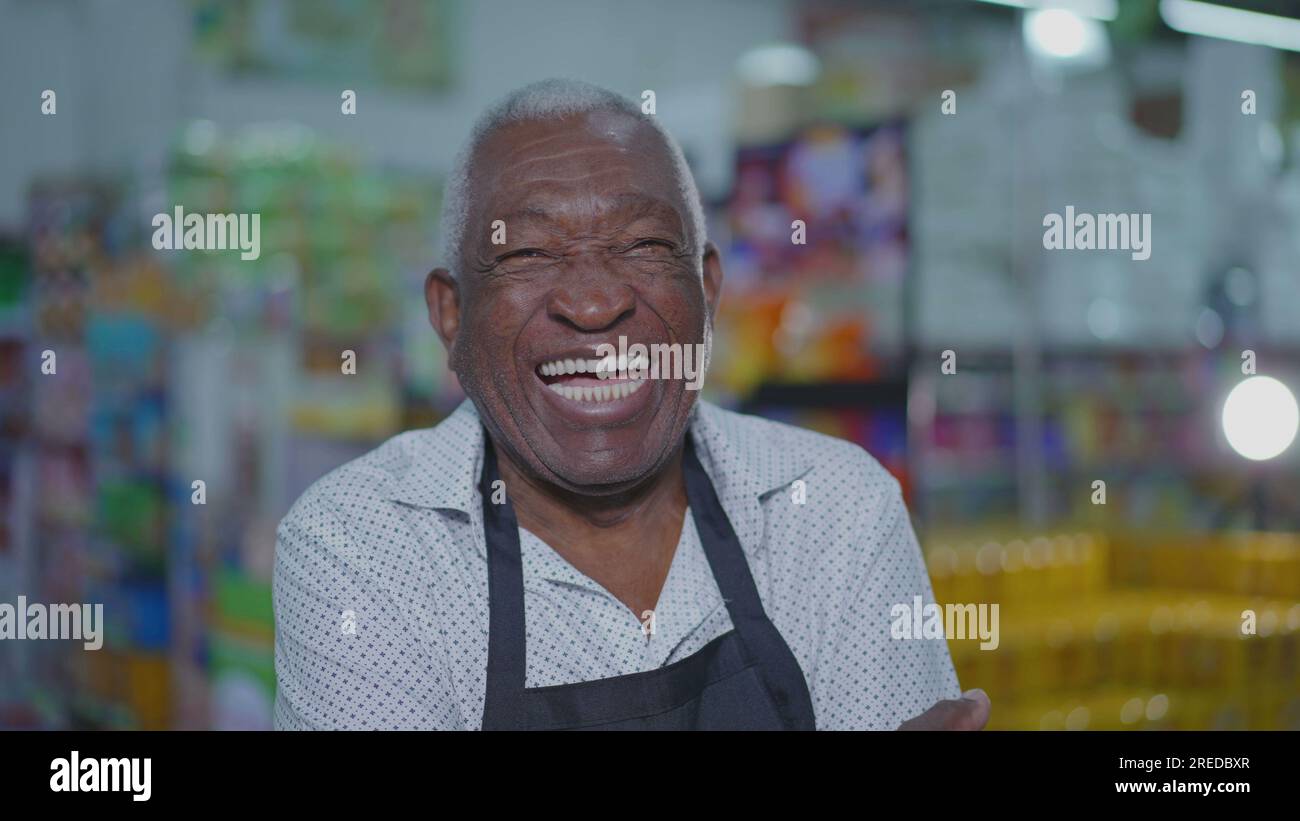 Happy African American manager of supermarket smiling and laughing with ...