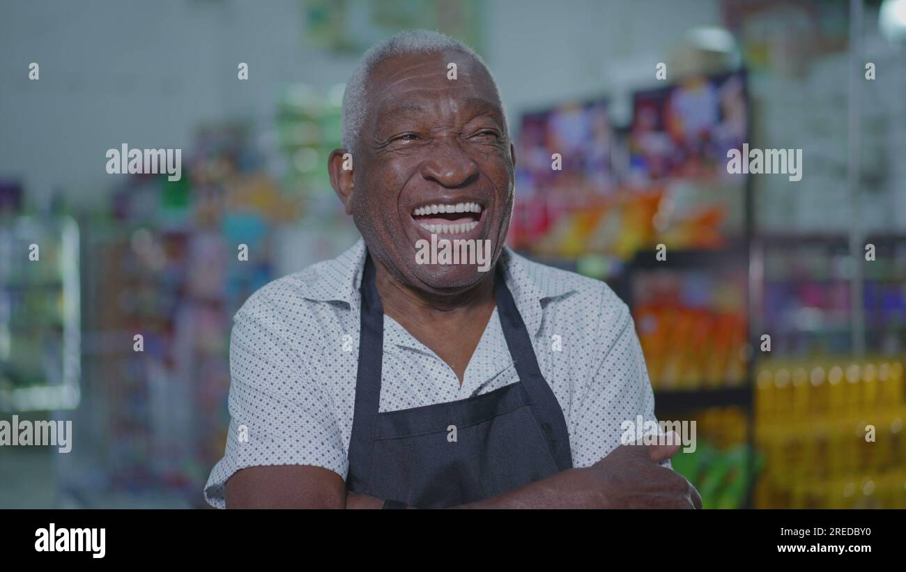 Happy African American manager of supermarket smiling and laughing with ...