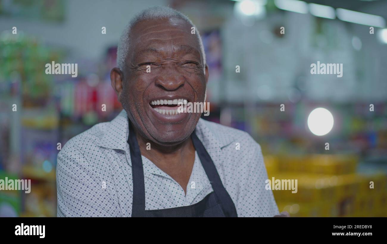 Happy African American manager of supermarket smiling and laughing with ...
