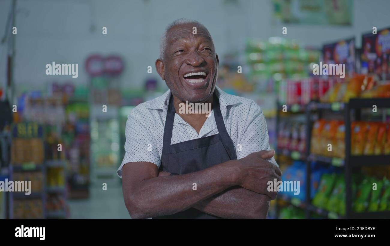 Happy African American employee and female customer laughing and ...