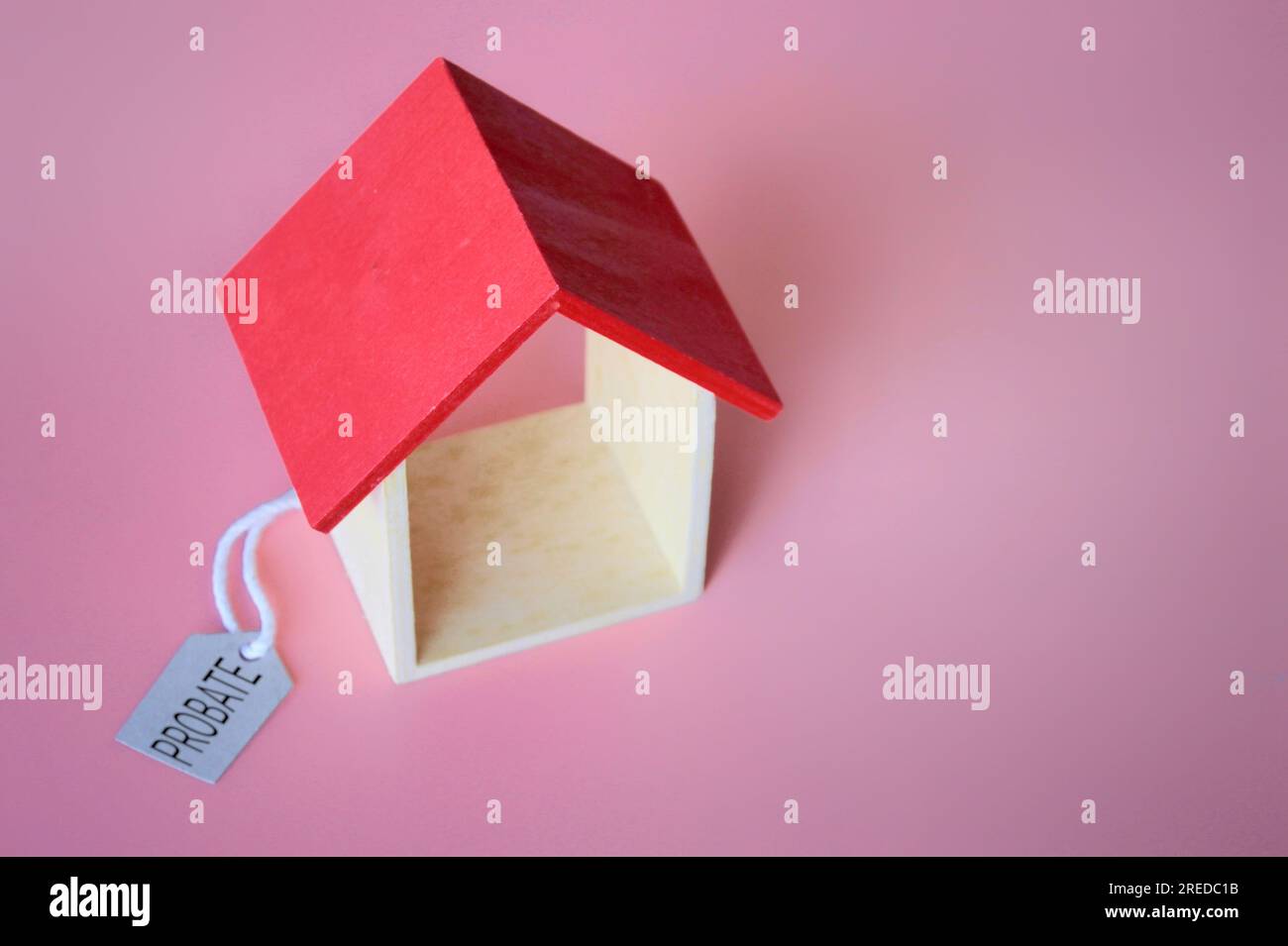House and tag PROBATE on pink background with copy space for text ...